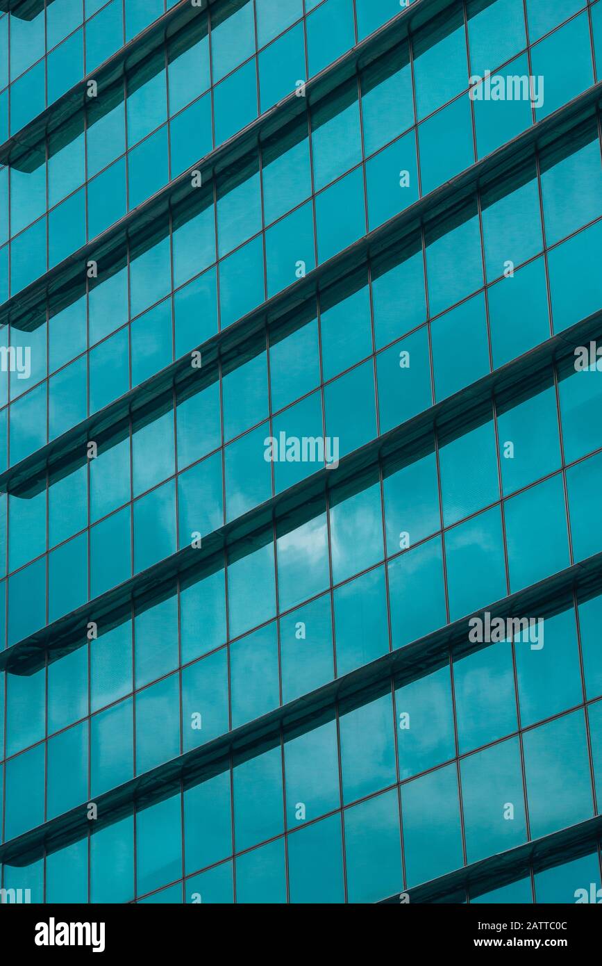 Futuristic skyscraper facade made out of blue glass square windows ...