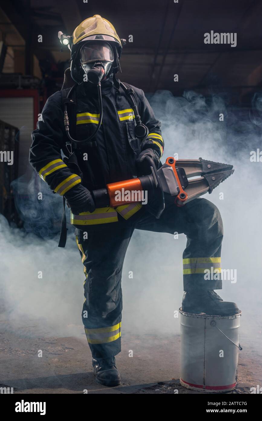 Portrait of a brave firefighter standing confident wearing full ...