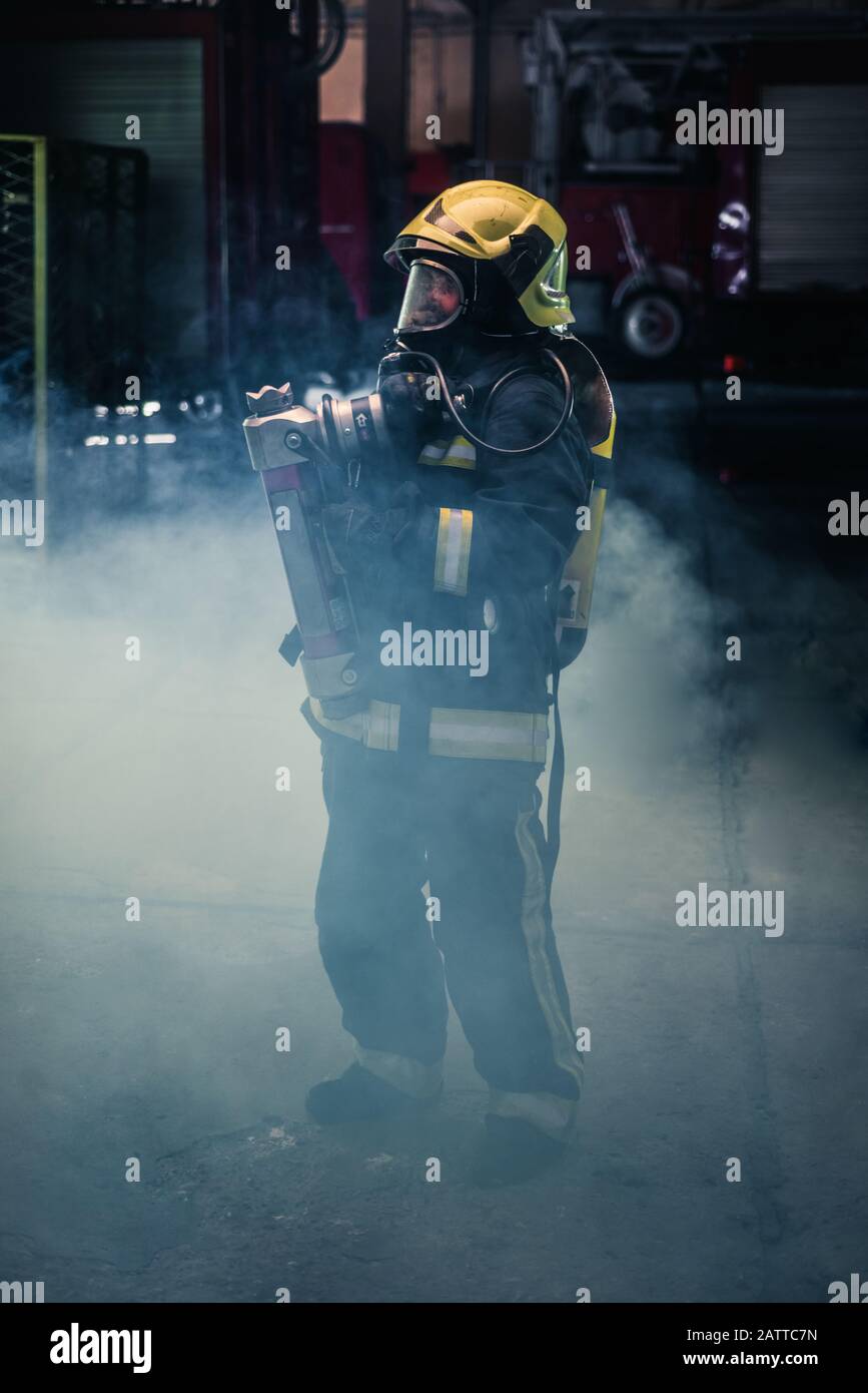 Portrait of a female firefighter wearing a helmet and all safety ...