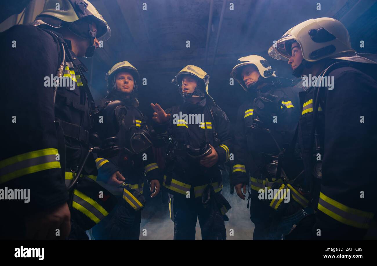 Group of firemen in the fire department organizing action plan for safe ...