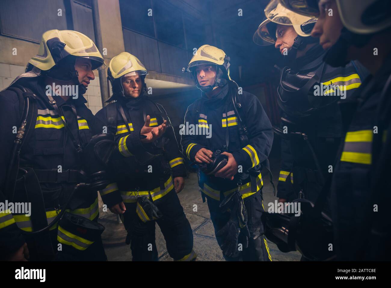 Group of firemen in the fire department organizing action plan for safe ...