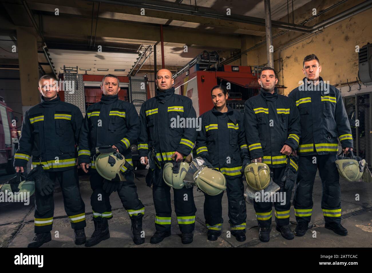 Portrait of firefighters standing by a fire engine Stock Photo - Alamy