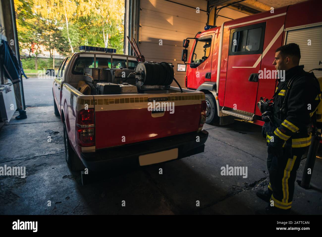 Fire engine truck parked inside the garage of the fire department Stock ...