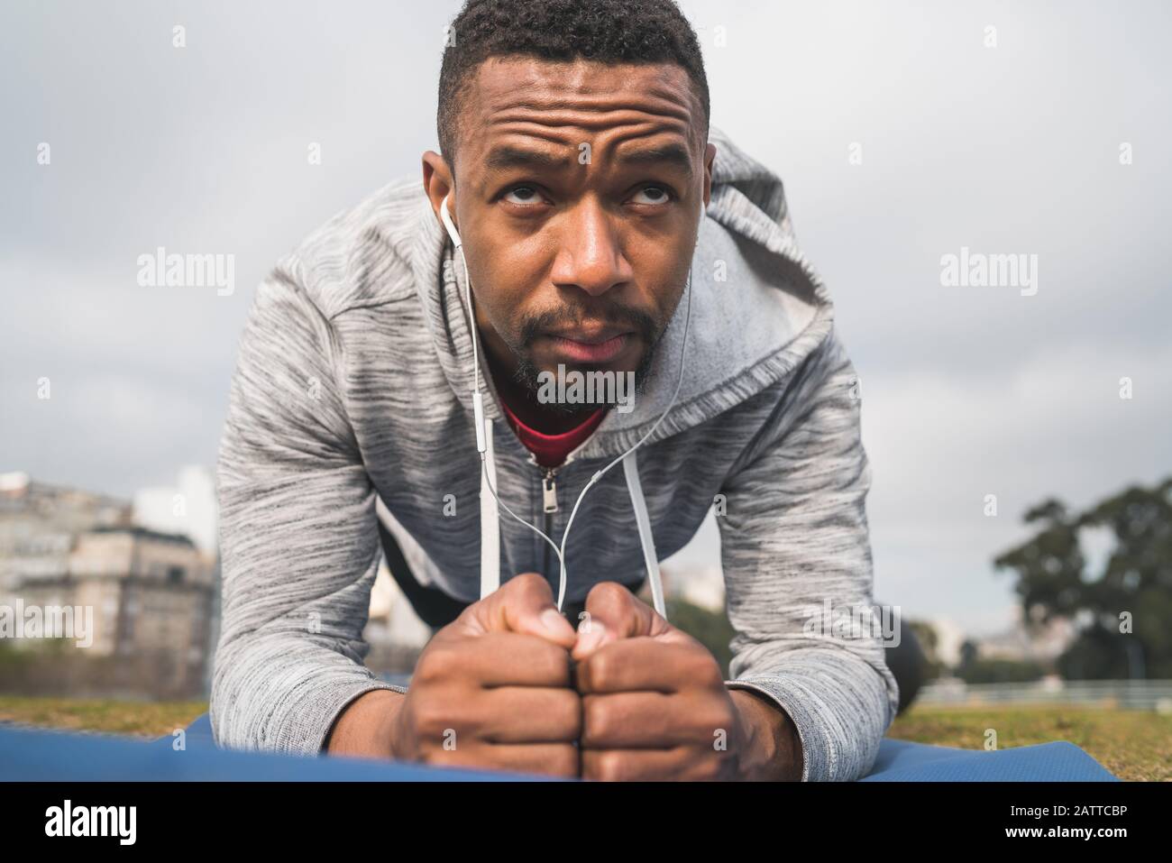 Portrait of an athletic man doing exercise at the park outdoors. Sport ...