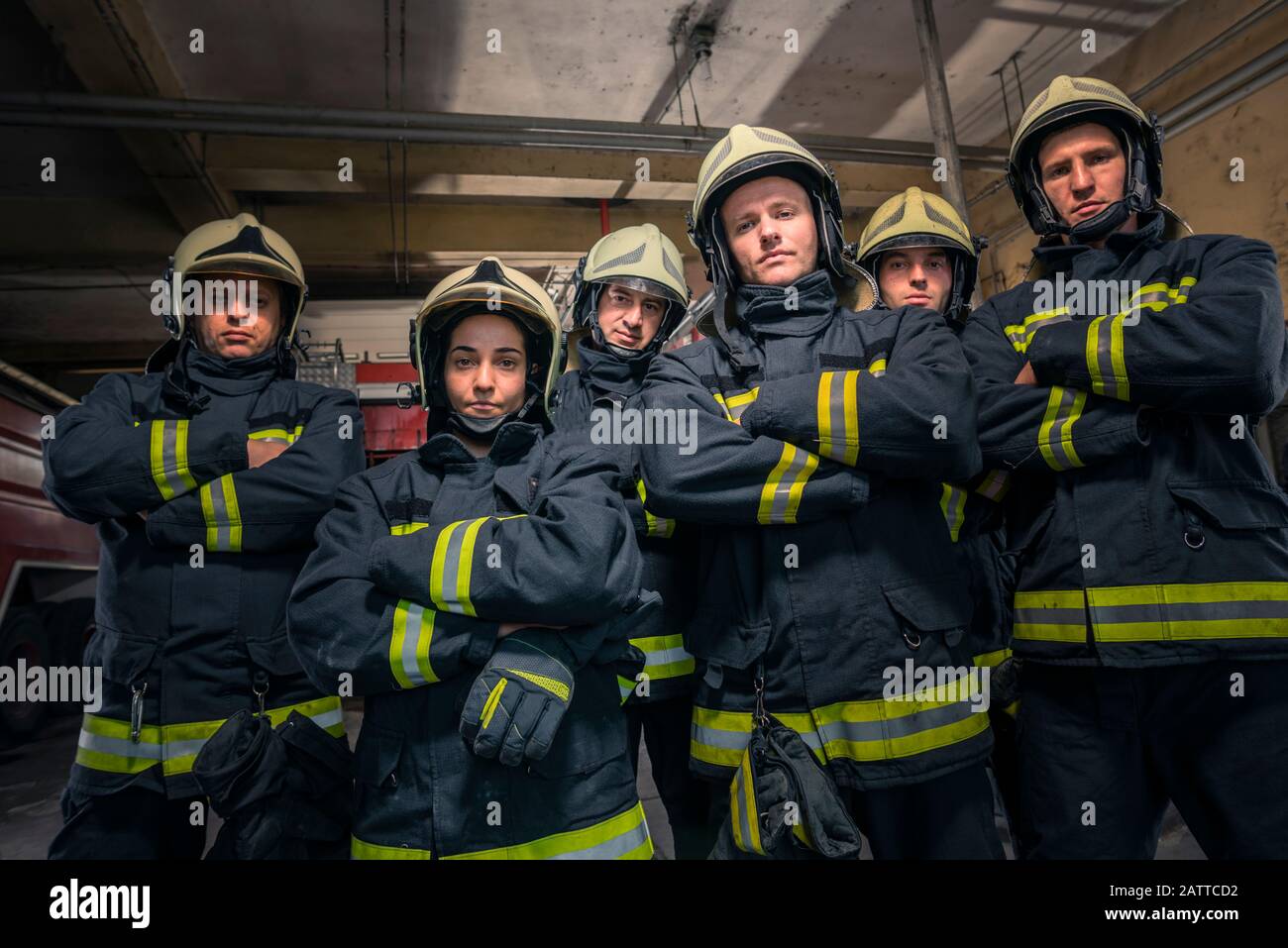 Group of firefighters standing confident with arms crossed. Firemen ...