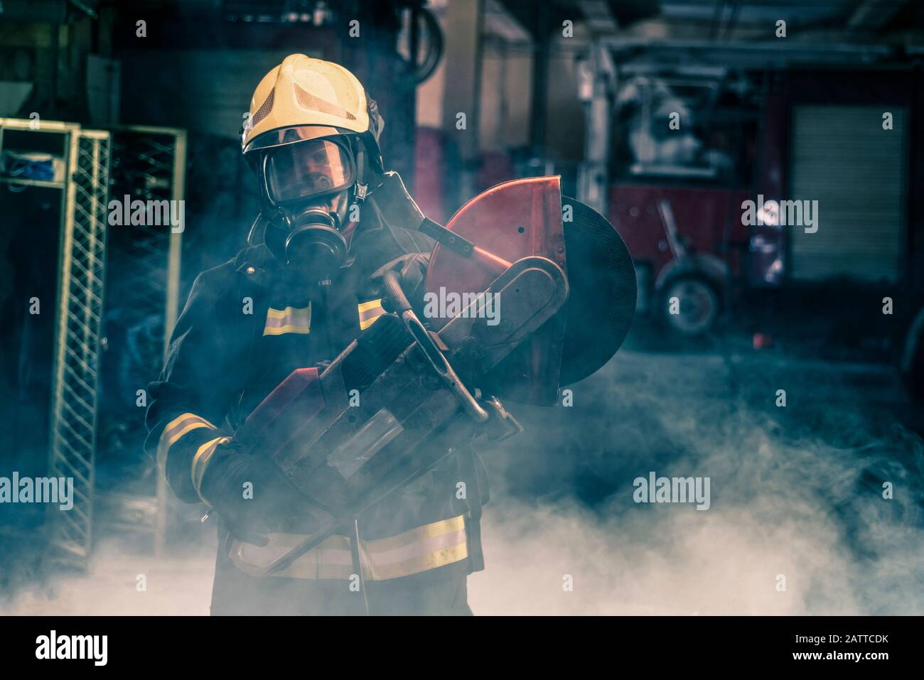 Portrait of a firefighter wearing full protective equipment posing with ...