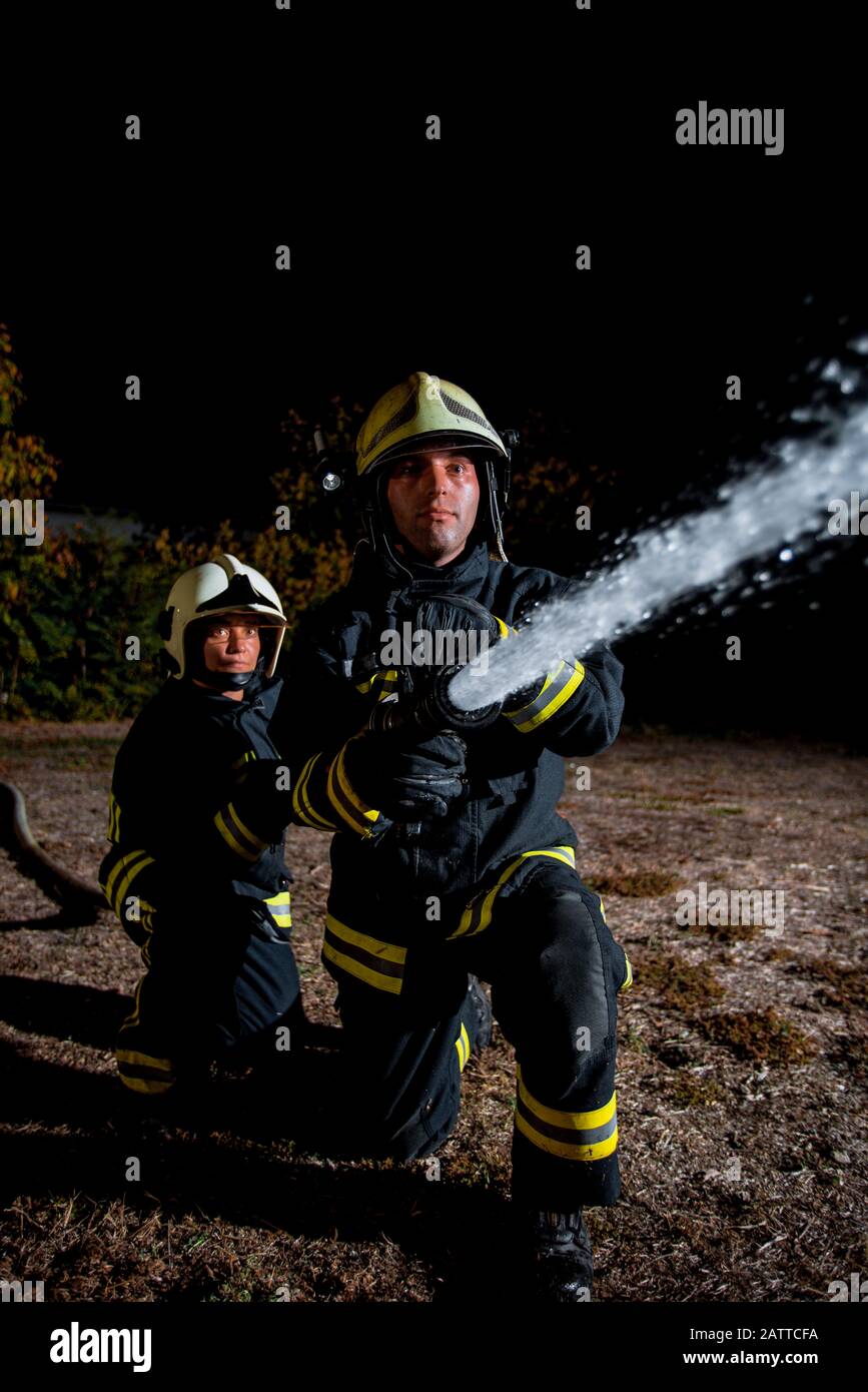 Firemen outfitted with protective gear during a firefighting operation ...
