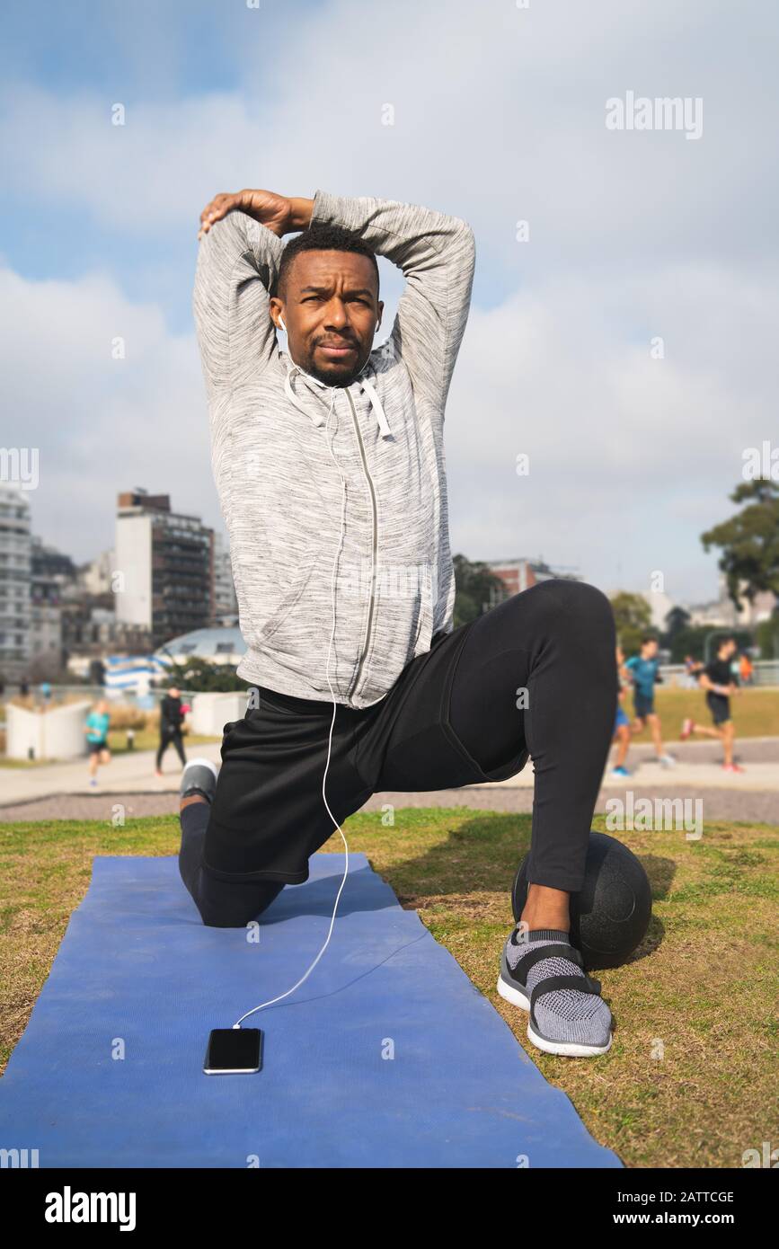 Portrait of an athletic man doing exercise at the park outdoors. Sport ...
