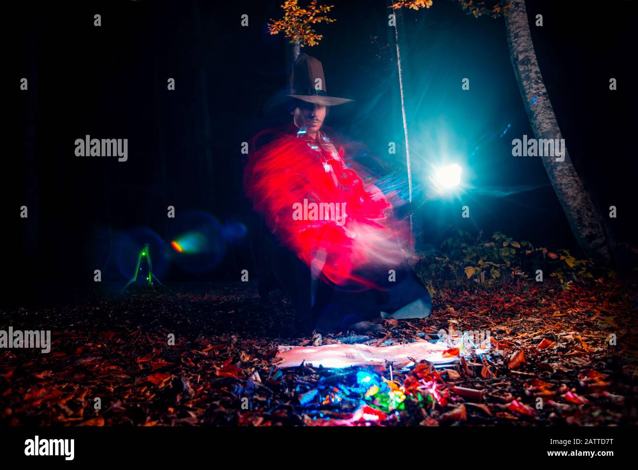 Wizard (mage) casting a spell with his magical staff while standing in ...