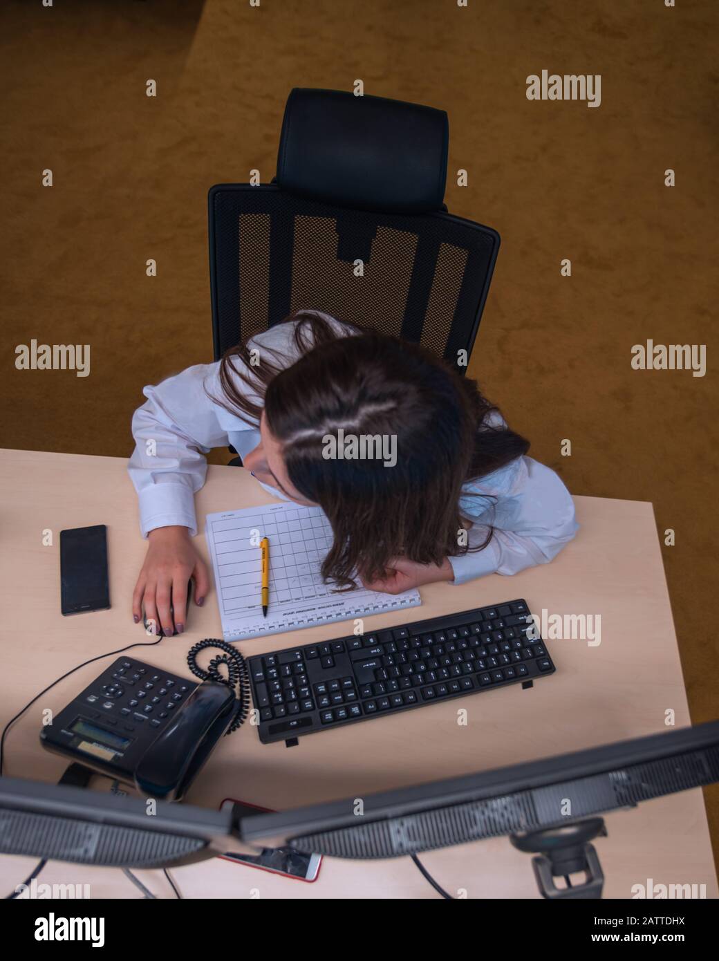 Female security guards working on computers while sitting in the main ...