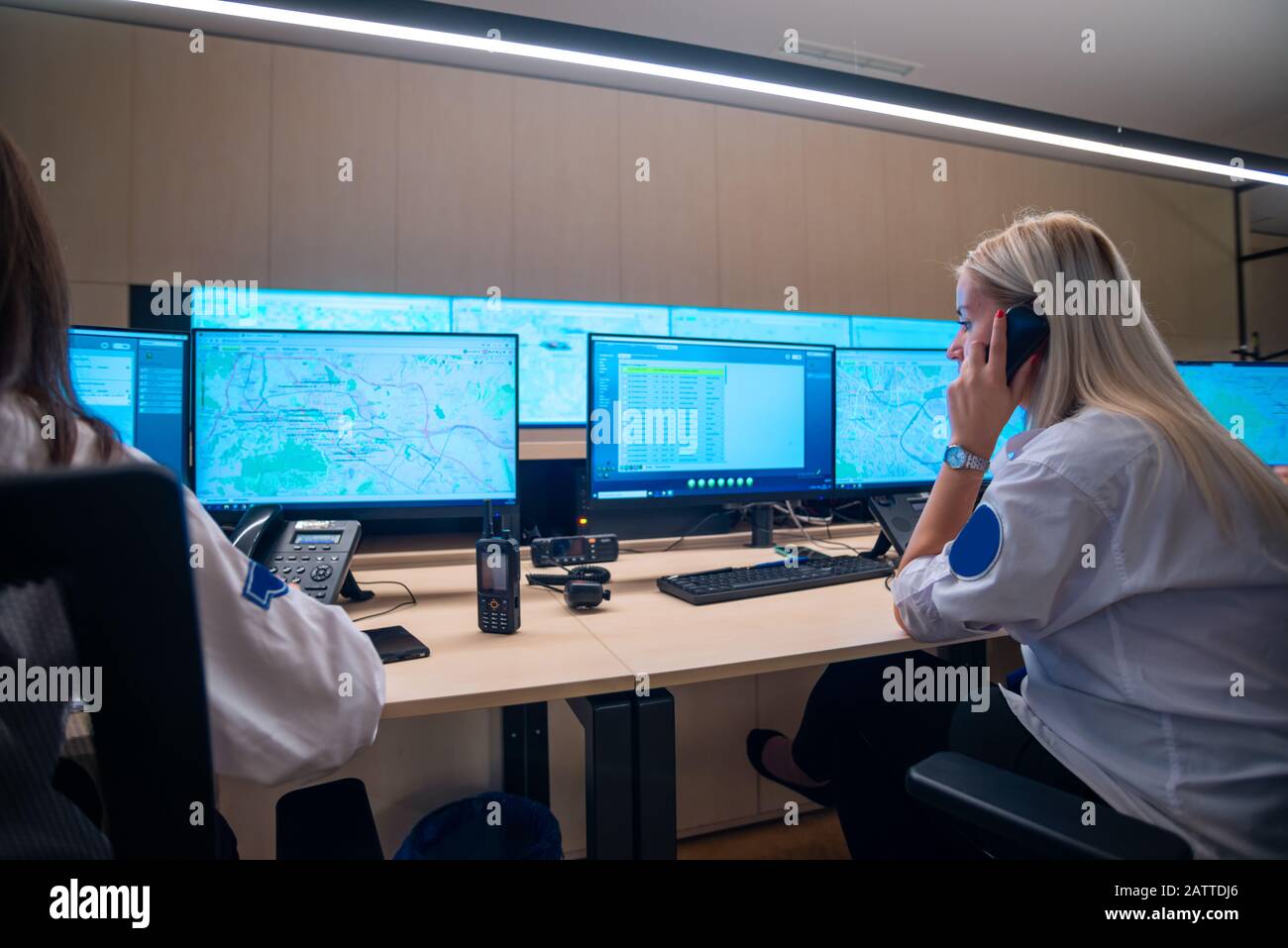 Female security guards working on computers while sitting in the main ...