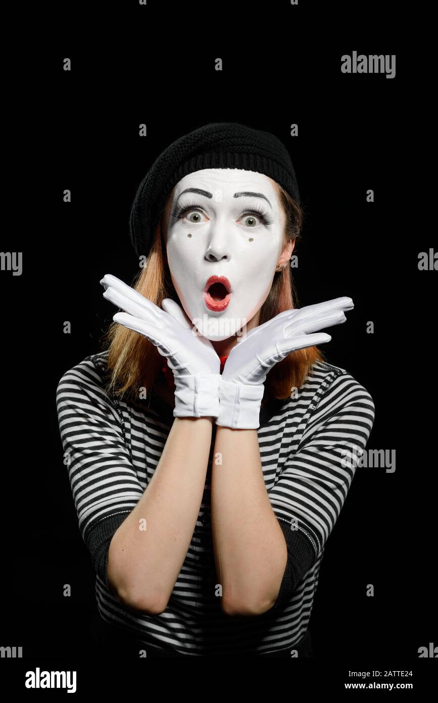 Amazed female mime on black. Vertical portrait of pantomime actress ...