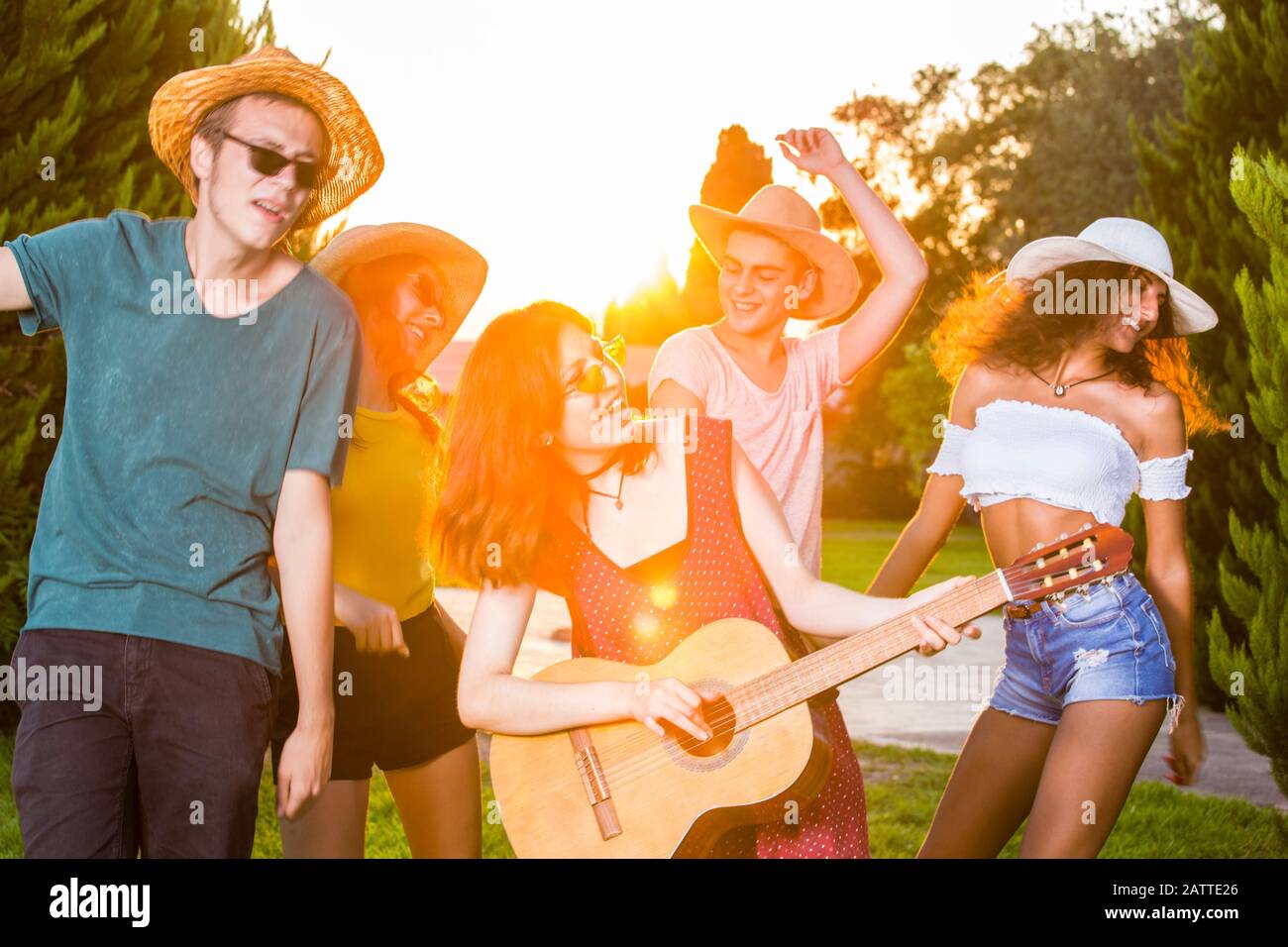 Group of happy young friends singing and dancing, enjoying summer in ...