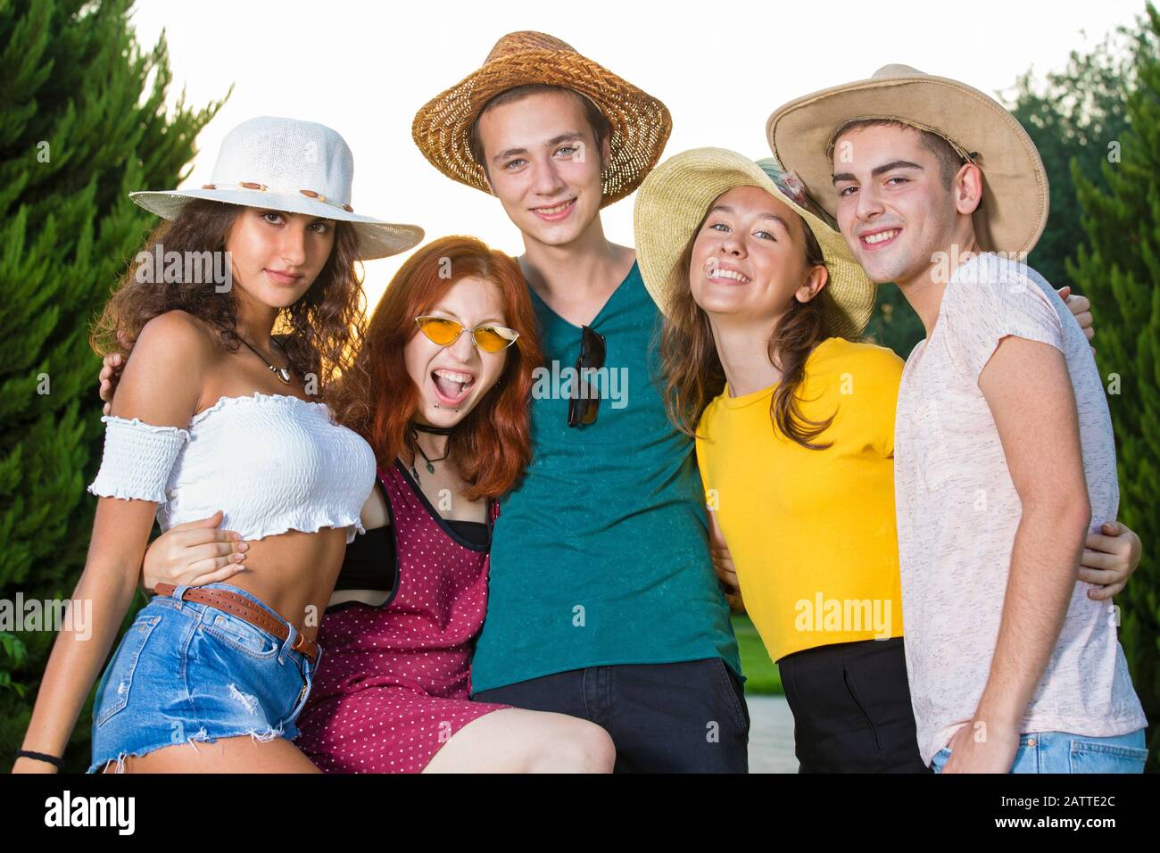 Group of young smiling students fooling around, partying outdoors in a ...