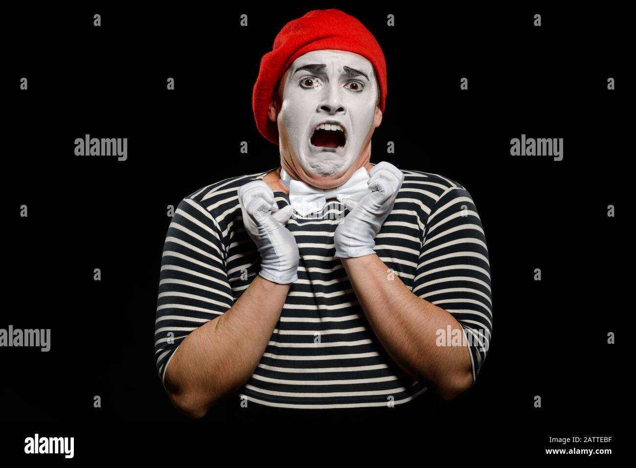 Frightened male mime, isolated on black. Lively emotions of an actor ...