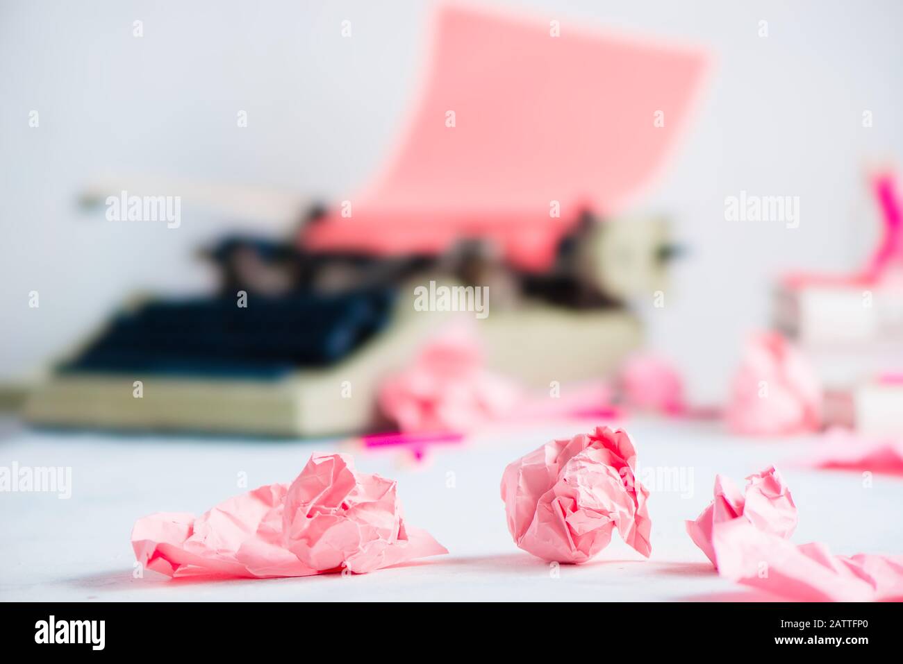 Crumpled paper balls and a typewriter on a writer workplace. Feminine ...