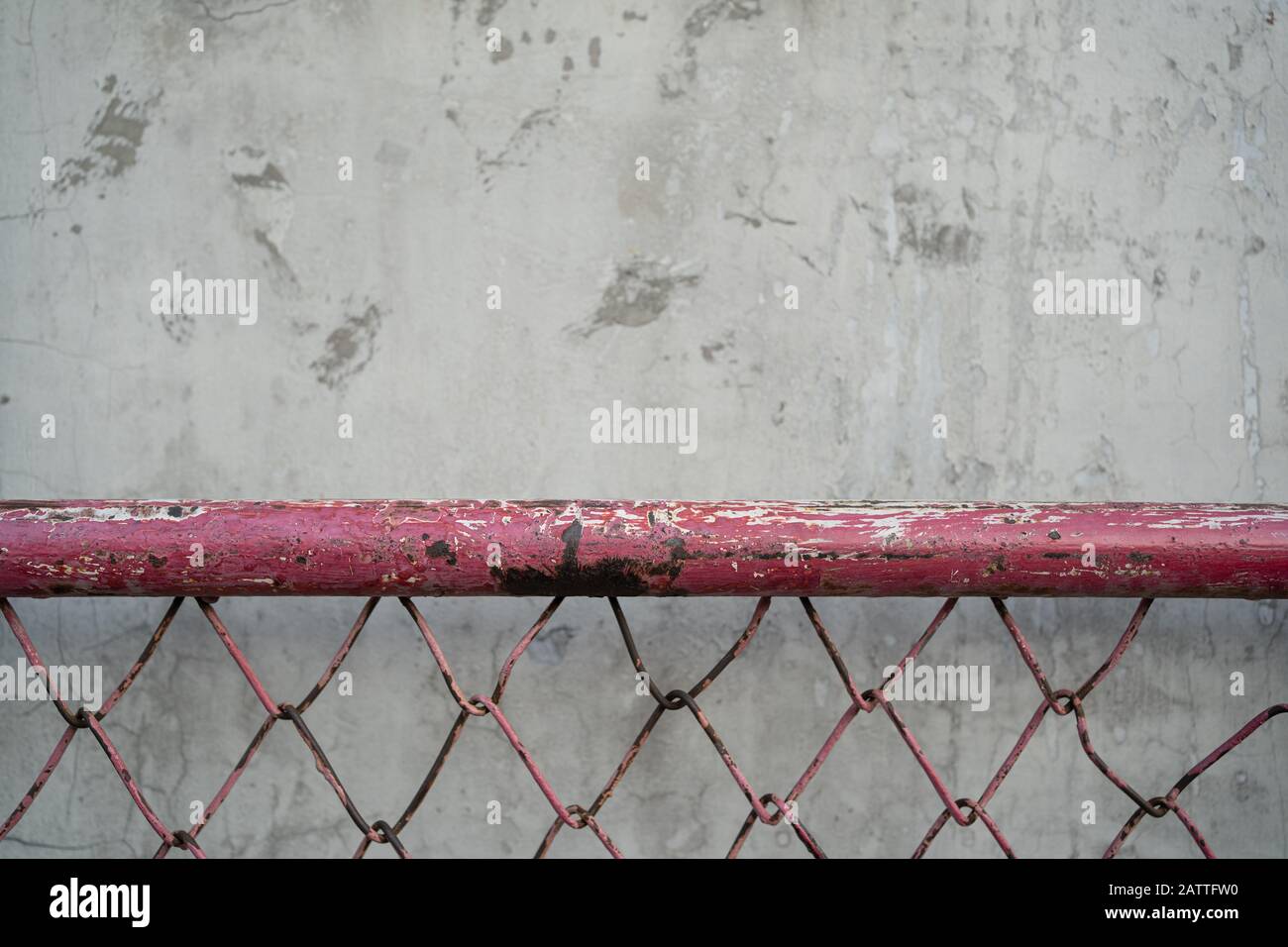 Concrete texture with red chain link fence Stock Photo - Alamy