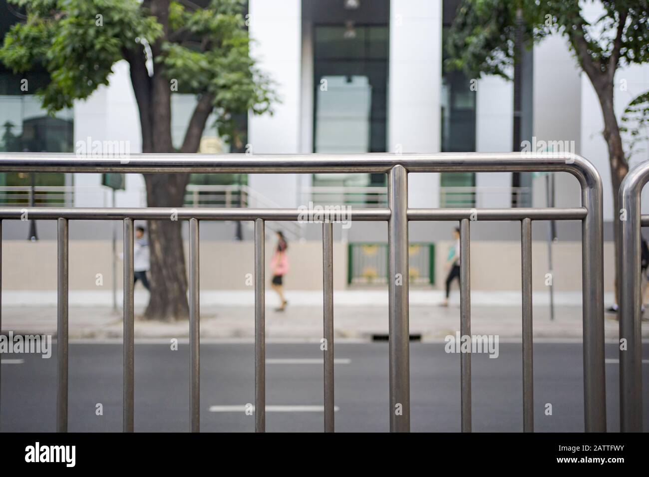 Pavement fence with pedestrian walking on clean footpath in the ...