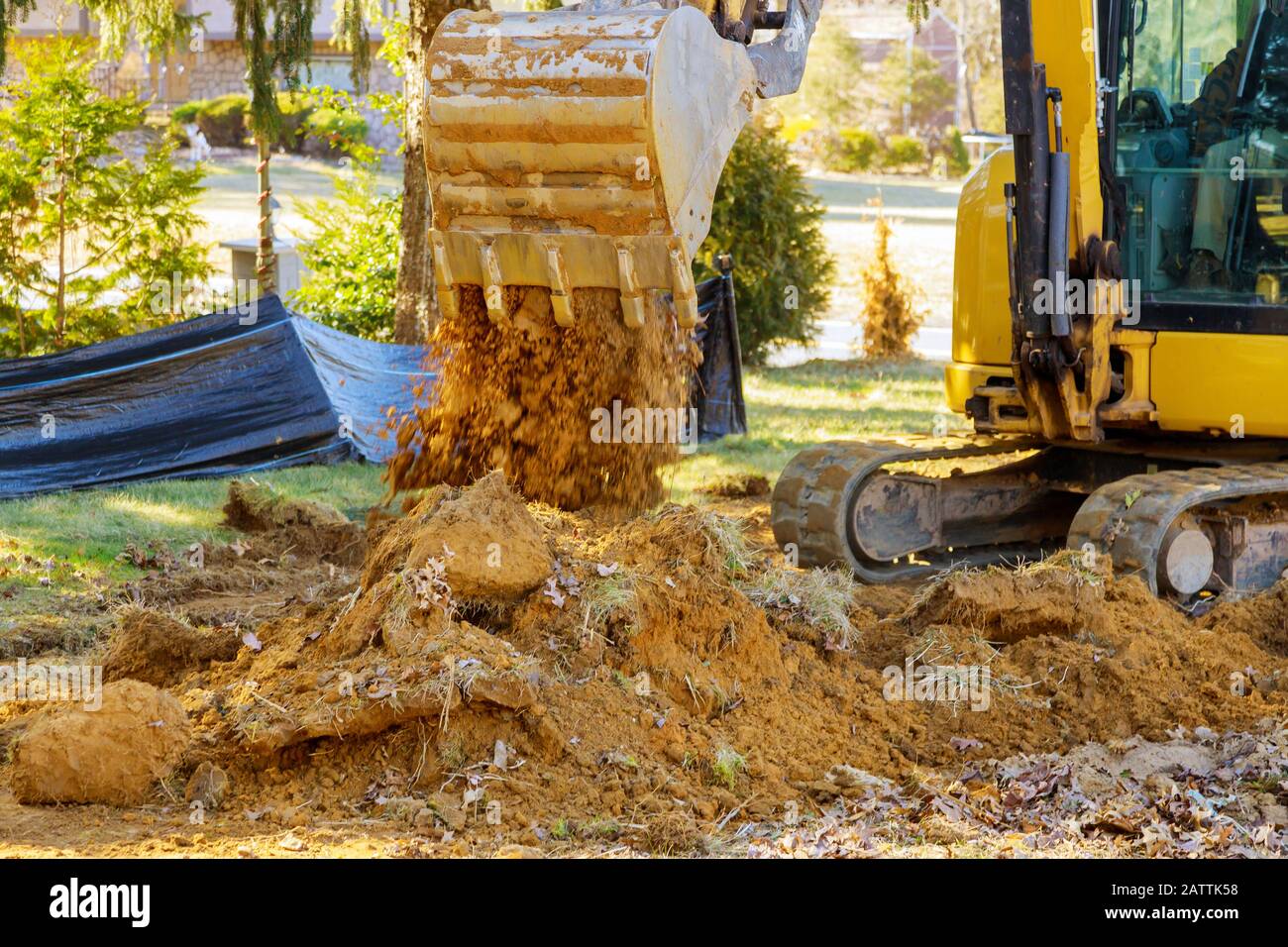 Excavator machine unloading soil earth moving construction works Stock ...