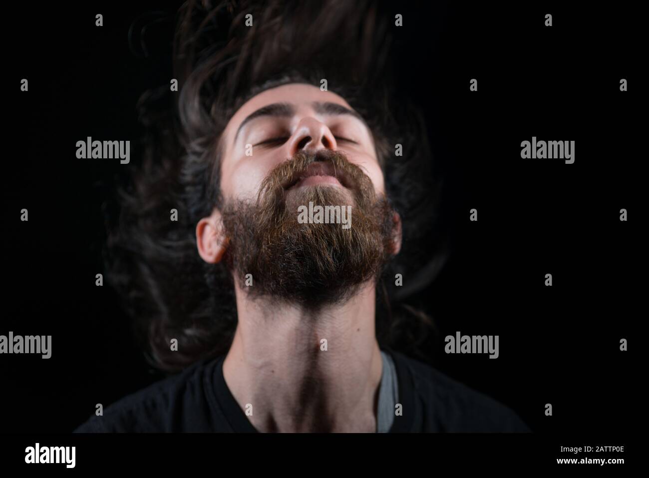 Hipster teenager man hair tossing, black isolated background. Freedom ...