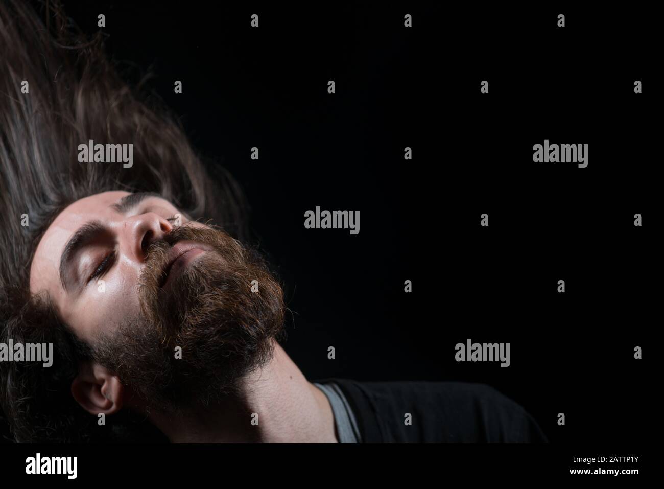 Hipster teenager man hair tossing, black isolated background. Freedom ...