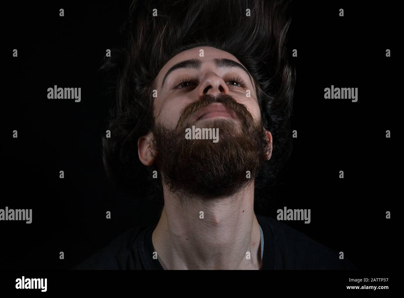 Hipster teenager man hair tossing, black isolated background. Freedom ...