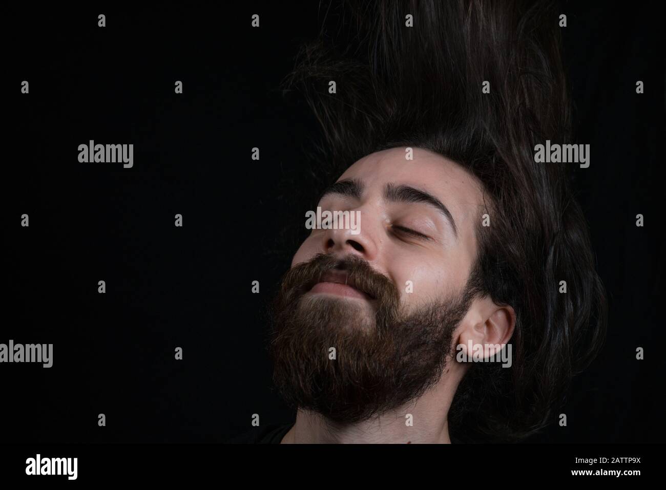 Hipster teenager man hair tossing, black isolated background. Freedom ...