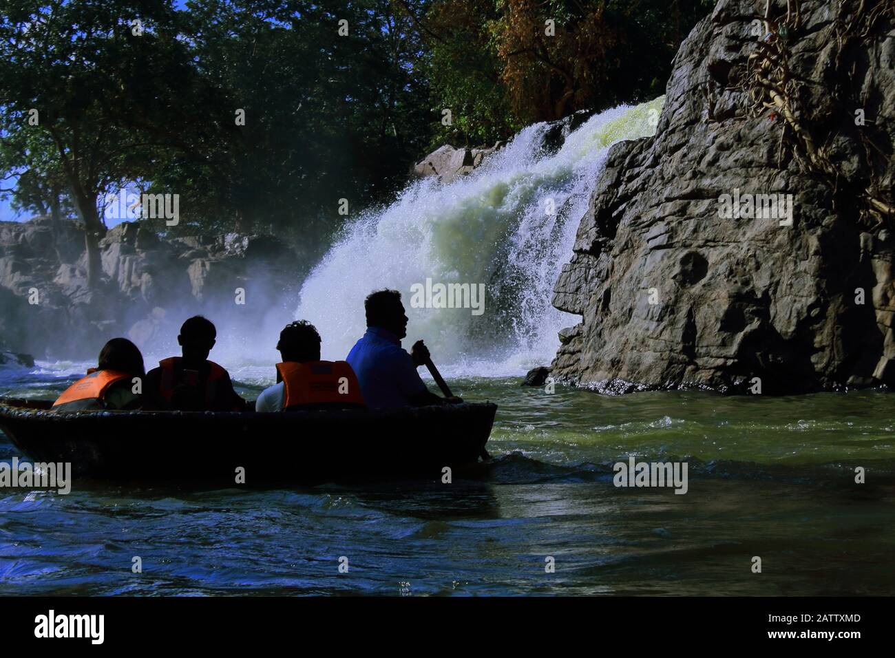 tourist enjoying a coracle ride on kaveri river at hogenakkal ...