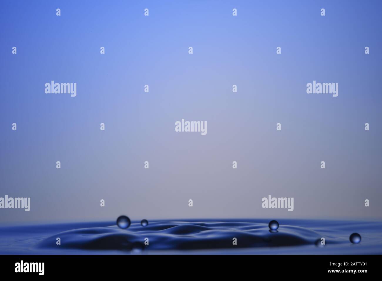 High-speed photography falling water drops into water Stock Photo - Alamy