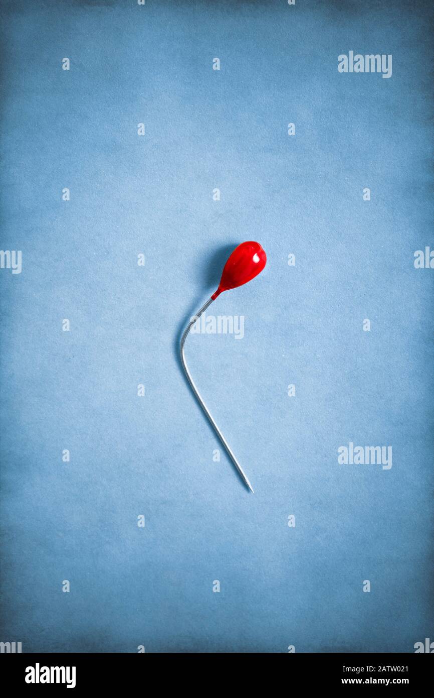 Bent Pin on Blue Ground Stock Photo - Alamy