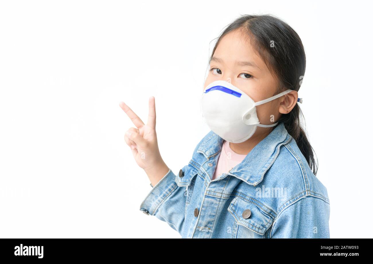 Asian girl wear N95 mask to protect PM 2.5 dust and show victory finger ...