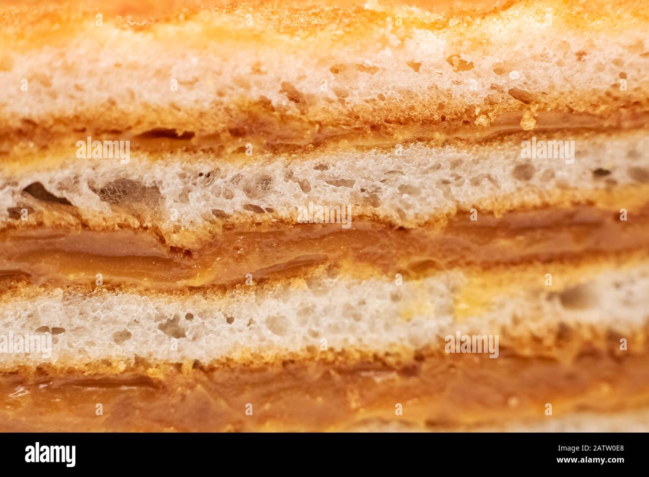 Layers of waffles with condensed milk closeup Stock Photo - Alamy