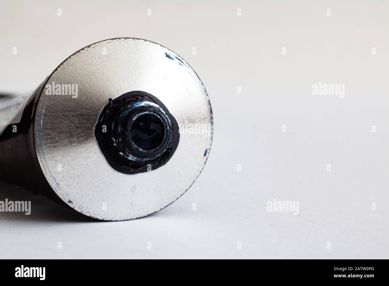 Open tube with blue paint on a white background Stock Photo - Alamy