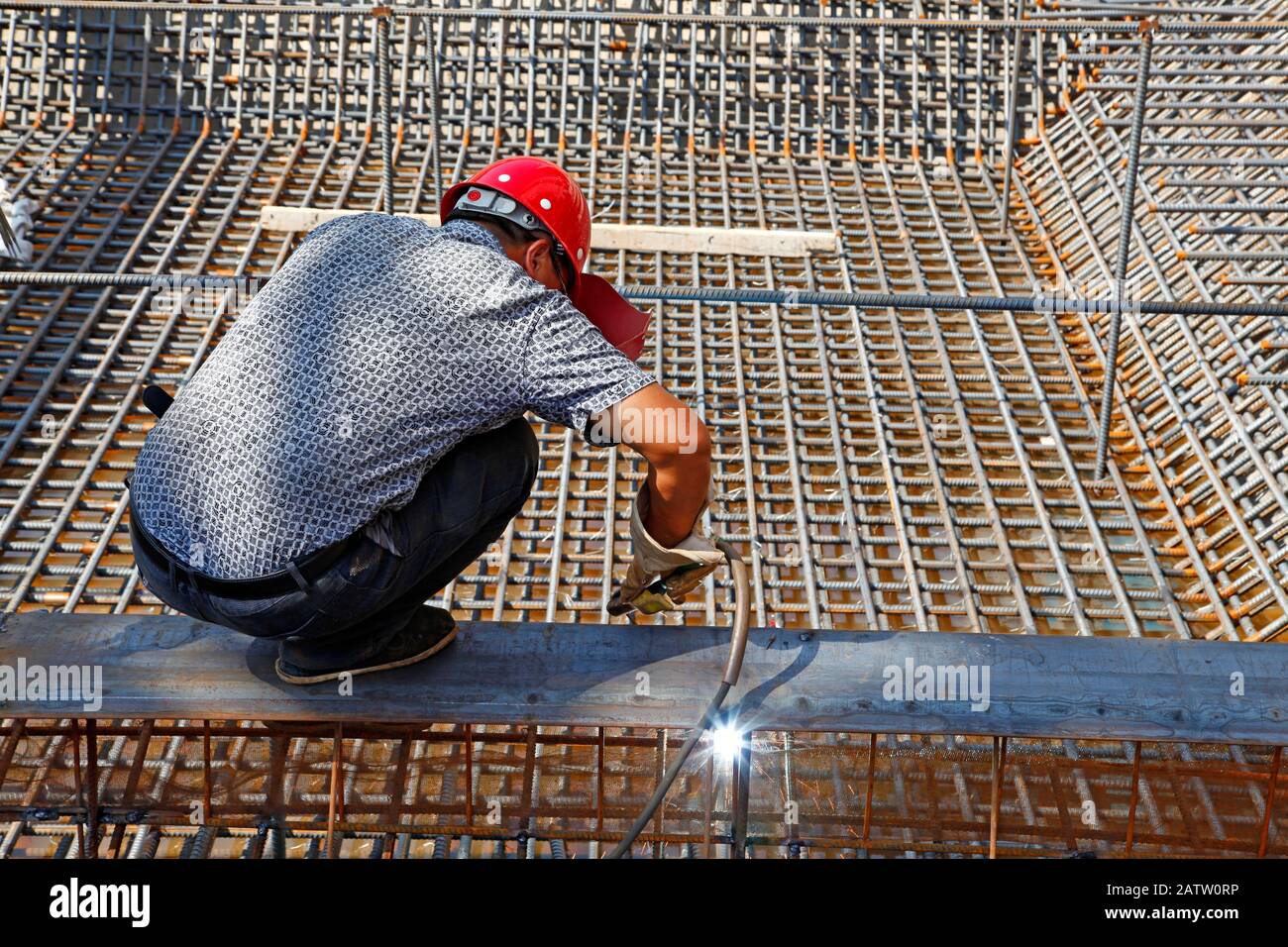 The welding worker in the construction site making reinforcement metal ...