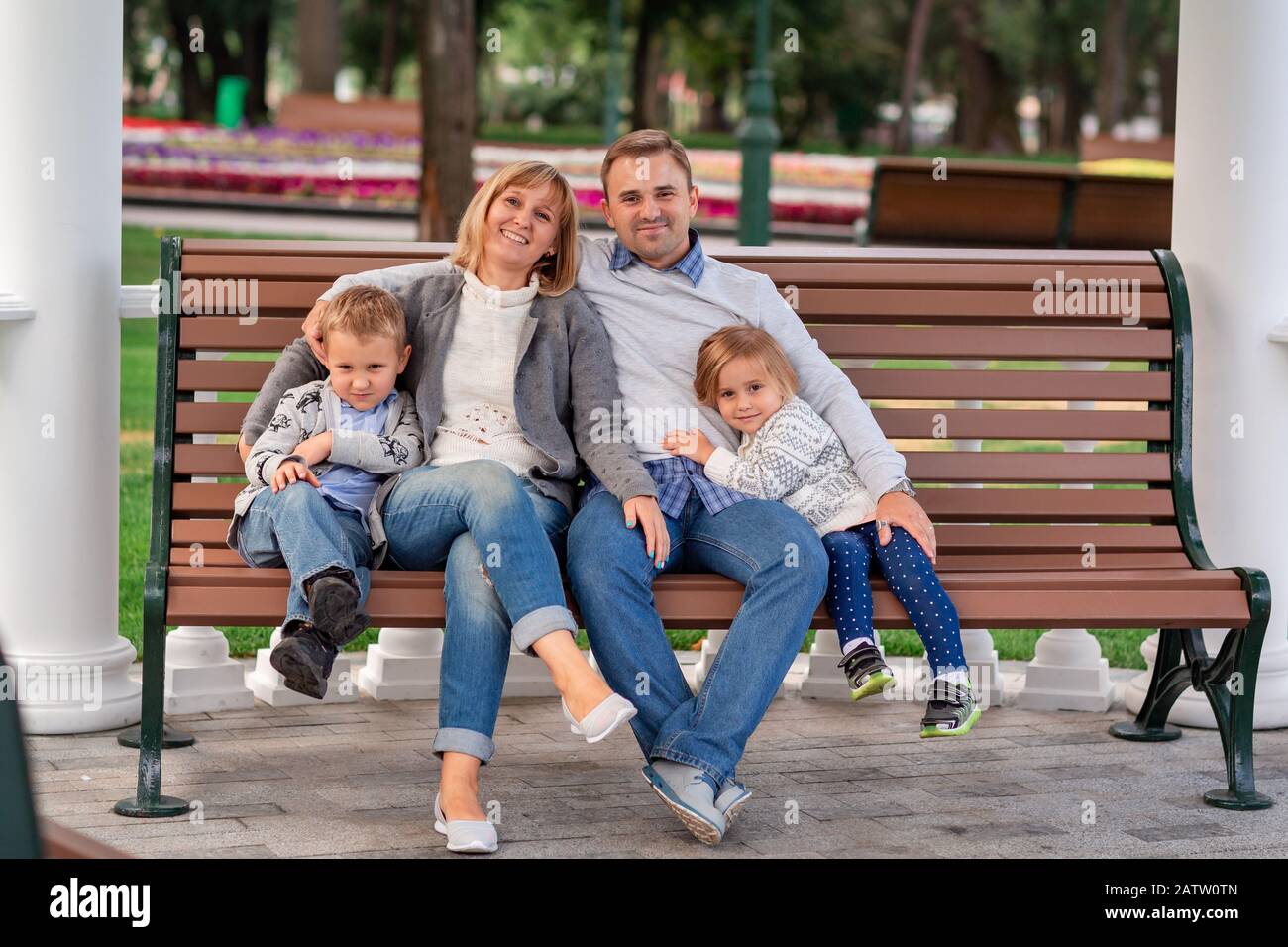 Happy family with two kids having fun together in the park outdoor ...