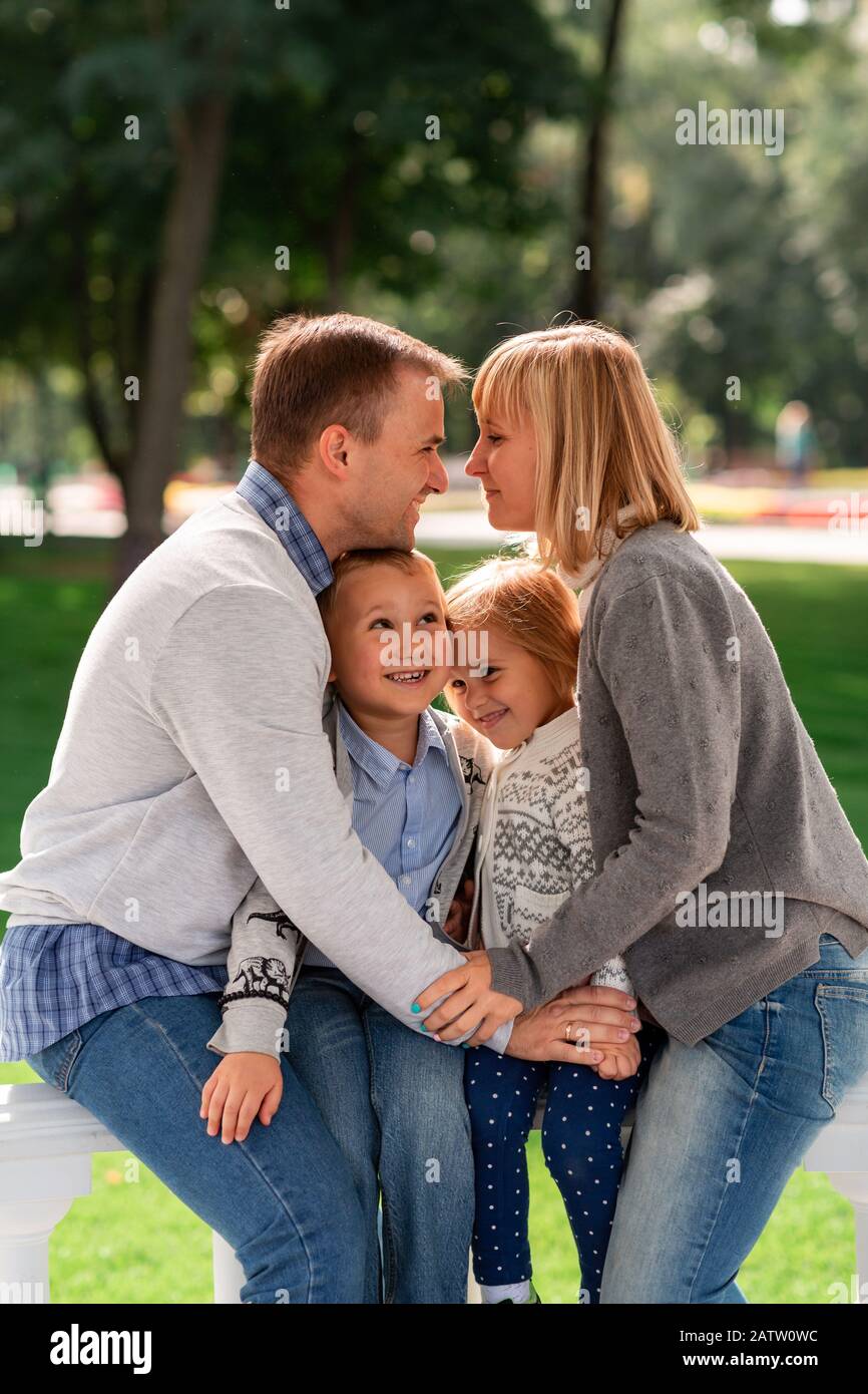 Happy family with two kids having fun together in the park outdoor ...