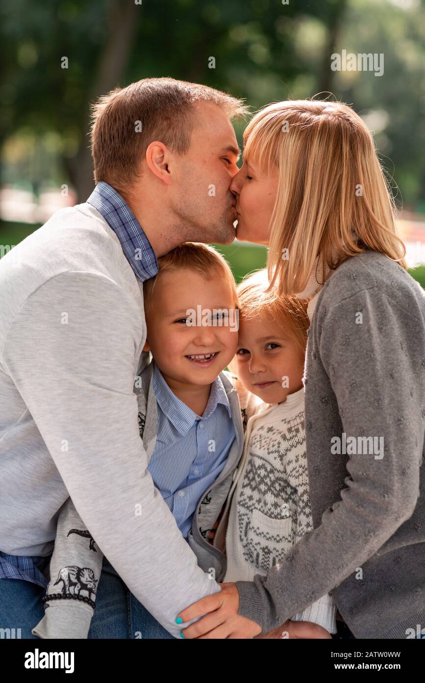 Happy family with two kids having fun together in the park outdoor ...