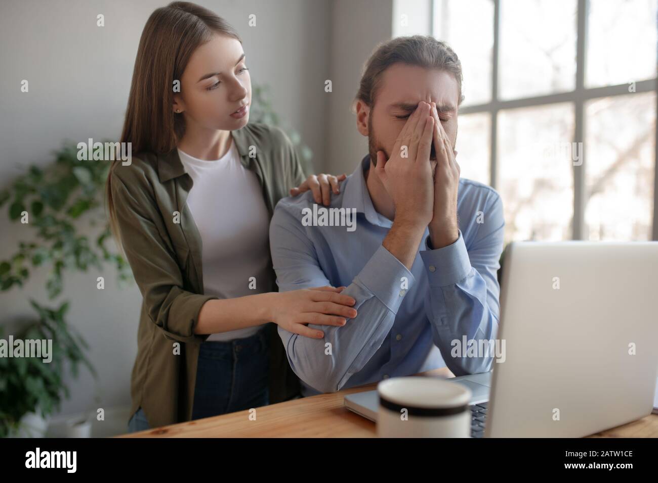 Getting support from colleagues. A woman supporting her upset male ...