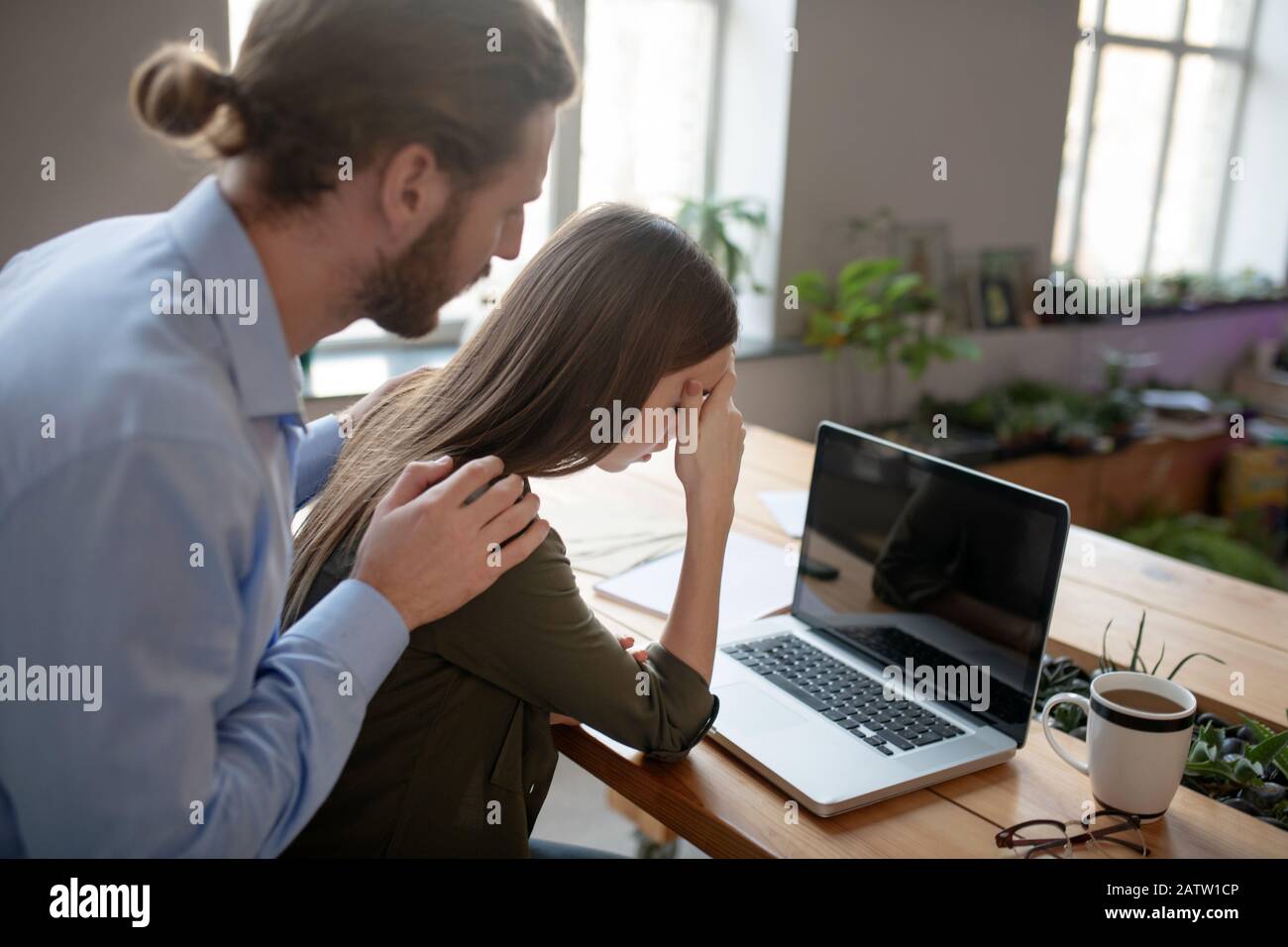 Supportive colleague. A man supporting a woman getting in trouble with ...