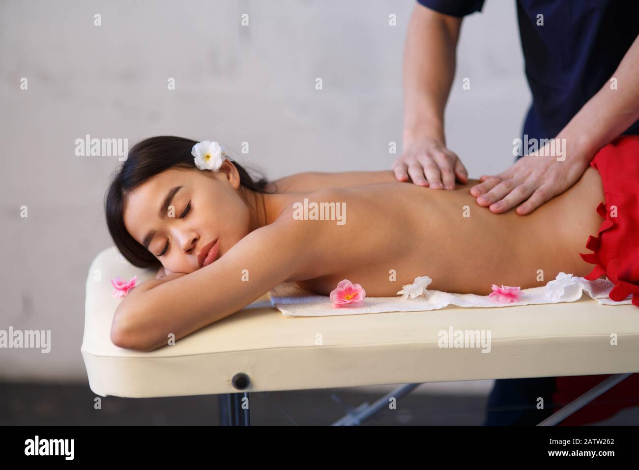 Male Masseur Does A Back Massage To A Girl Of Asian Appearance