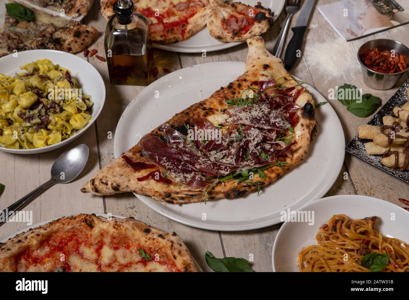 Traditional Neapolitan dishes. Calzone, Iberian, pizzas, pasta dish ...