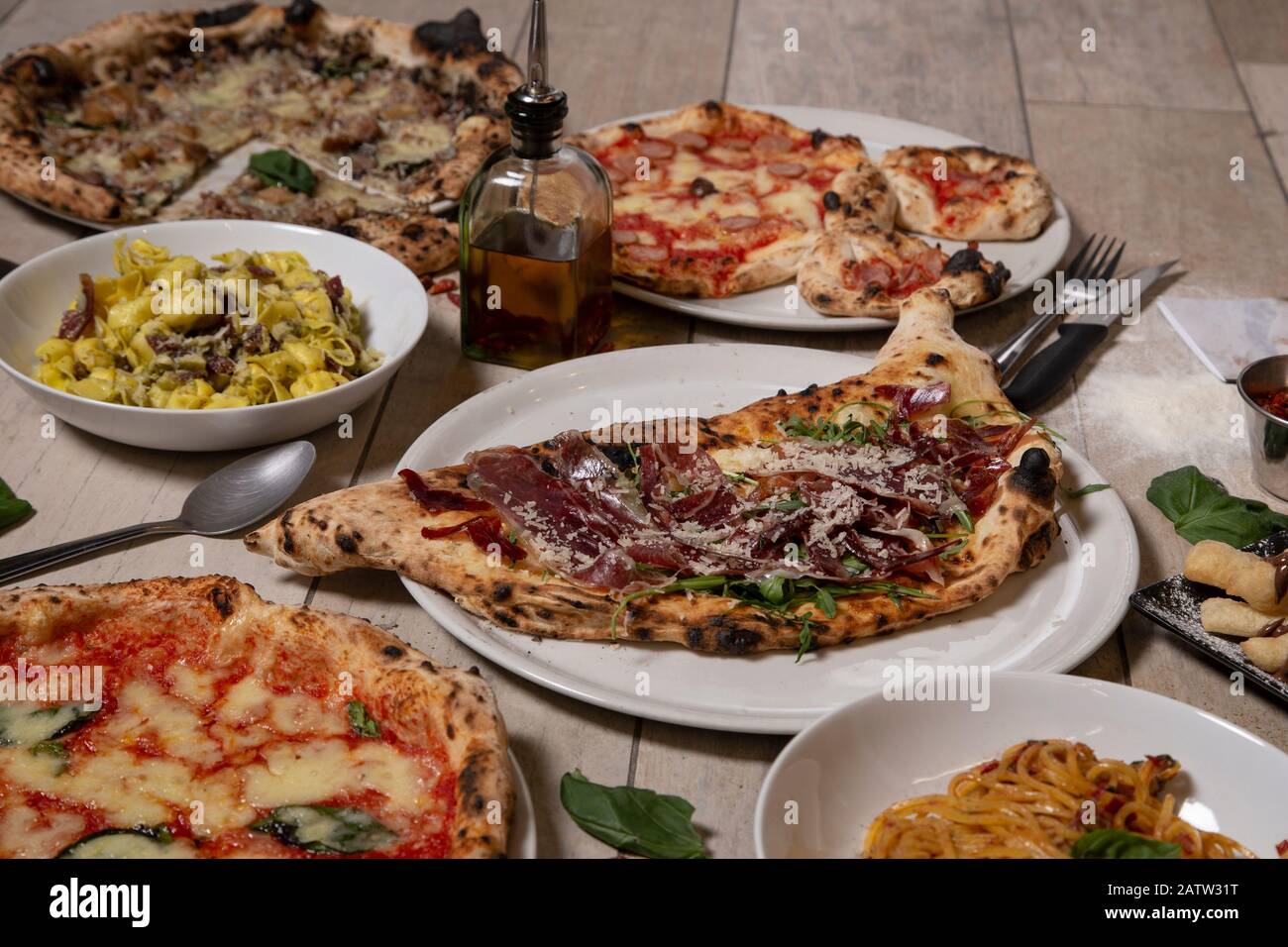 Traditional Neapolitan dishes. Calzone, Iberian, pizzas, pasta dish ...
