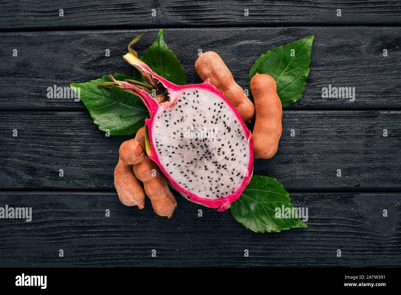 Dragon is a fruit and tamarind. Fresh Tropical Fruits. On a wooden ...