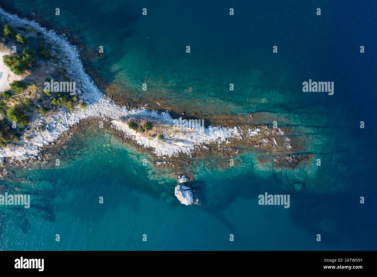 Aerial view from flying drone of a small peninsula with calm turquoise ...