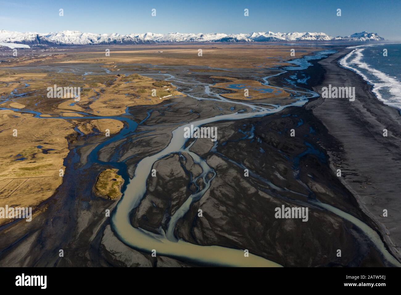 Aerial view of patterns of Icelandic rivers flowing into the ocean ...