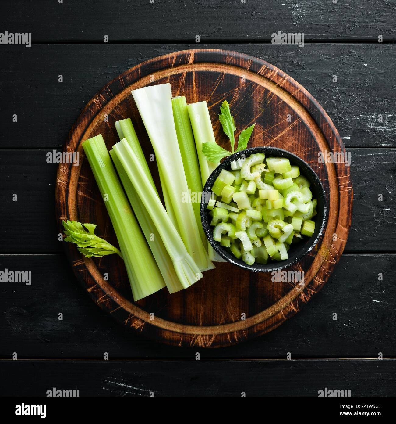 Fresh green celery stalk on a black background. Healthy food. Top view ...