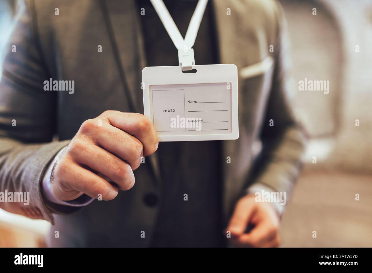 Businessman at an exhibition or conference showing a blank security identity name card Stock ...