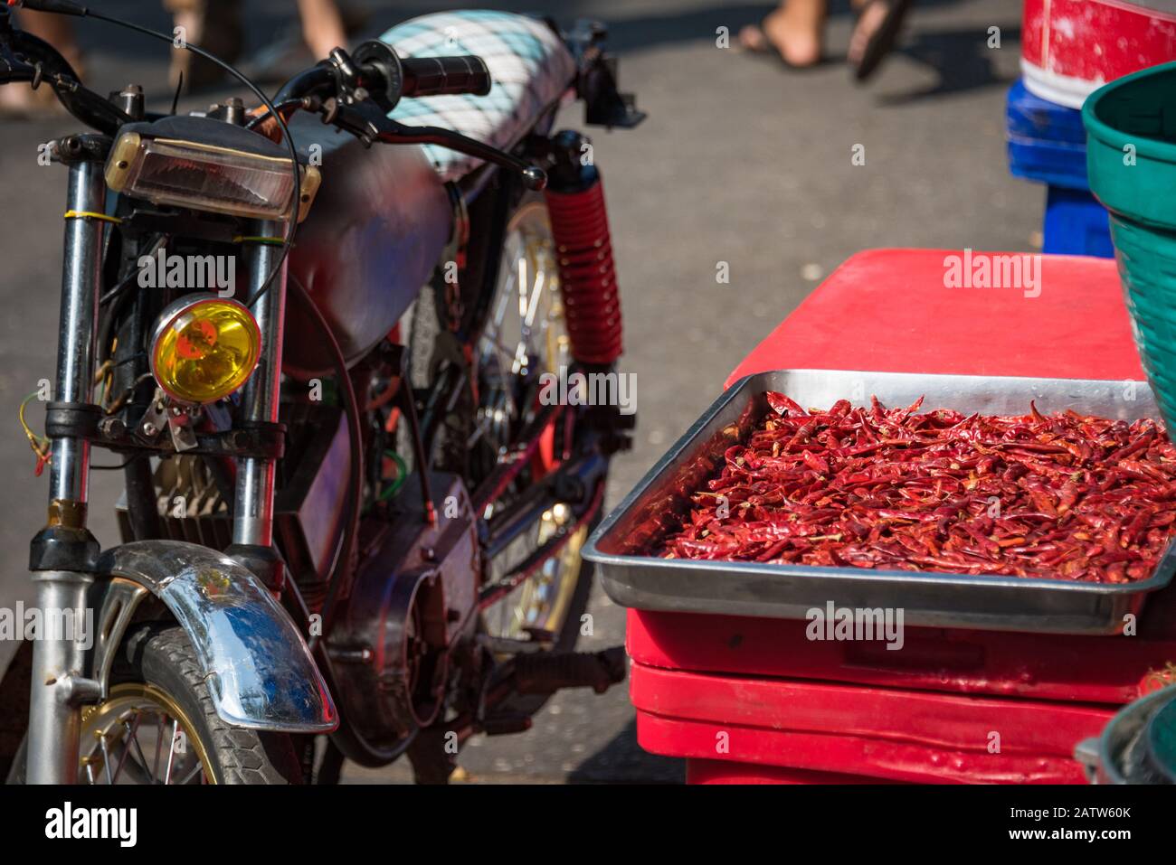 Thai street food scene with dry red chilli peper and motor bicycle ...