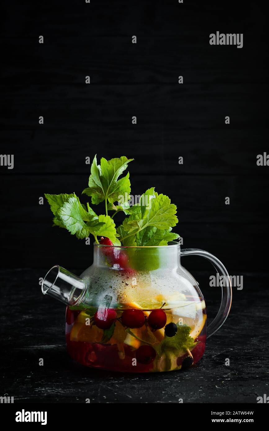 Forest berry and fruit tea. Hot winter drinks. On a black background ...