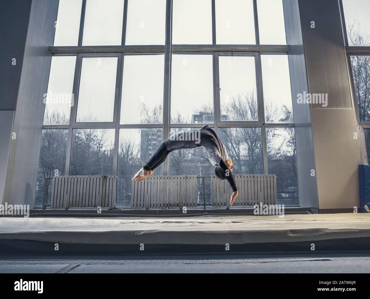 Flying. Little male gymnast training in gym, flexible and active ...